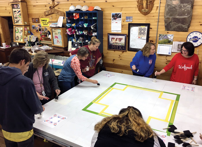 Millbridge Elementary staff works together to create barn quilt square ...